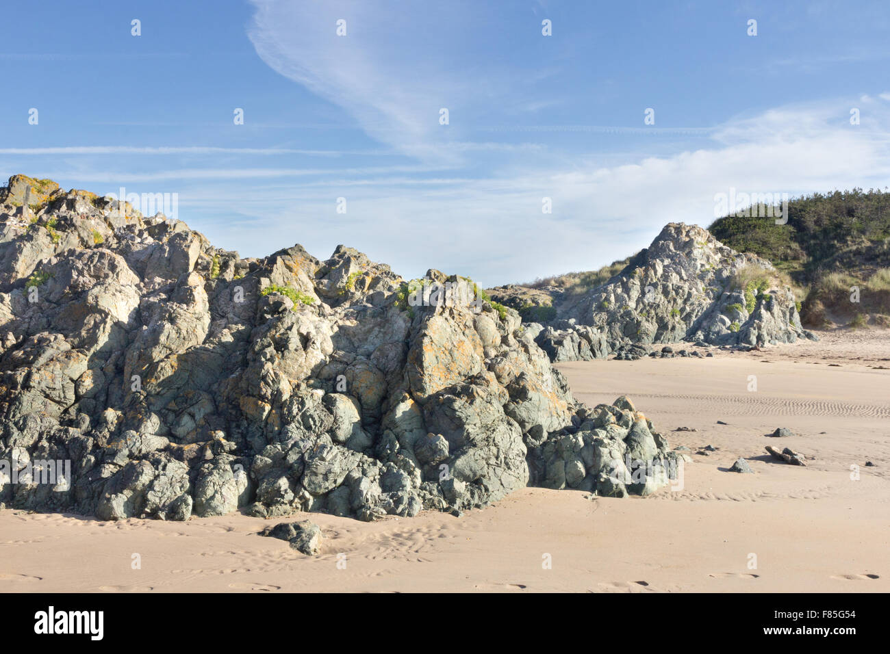 Volcanic rocks on Newborough Beach, Anglesey, Wales Stock Photo - Alamy