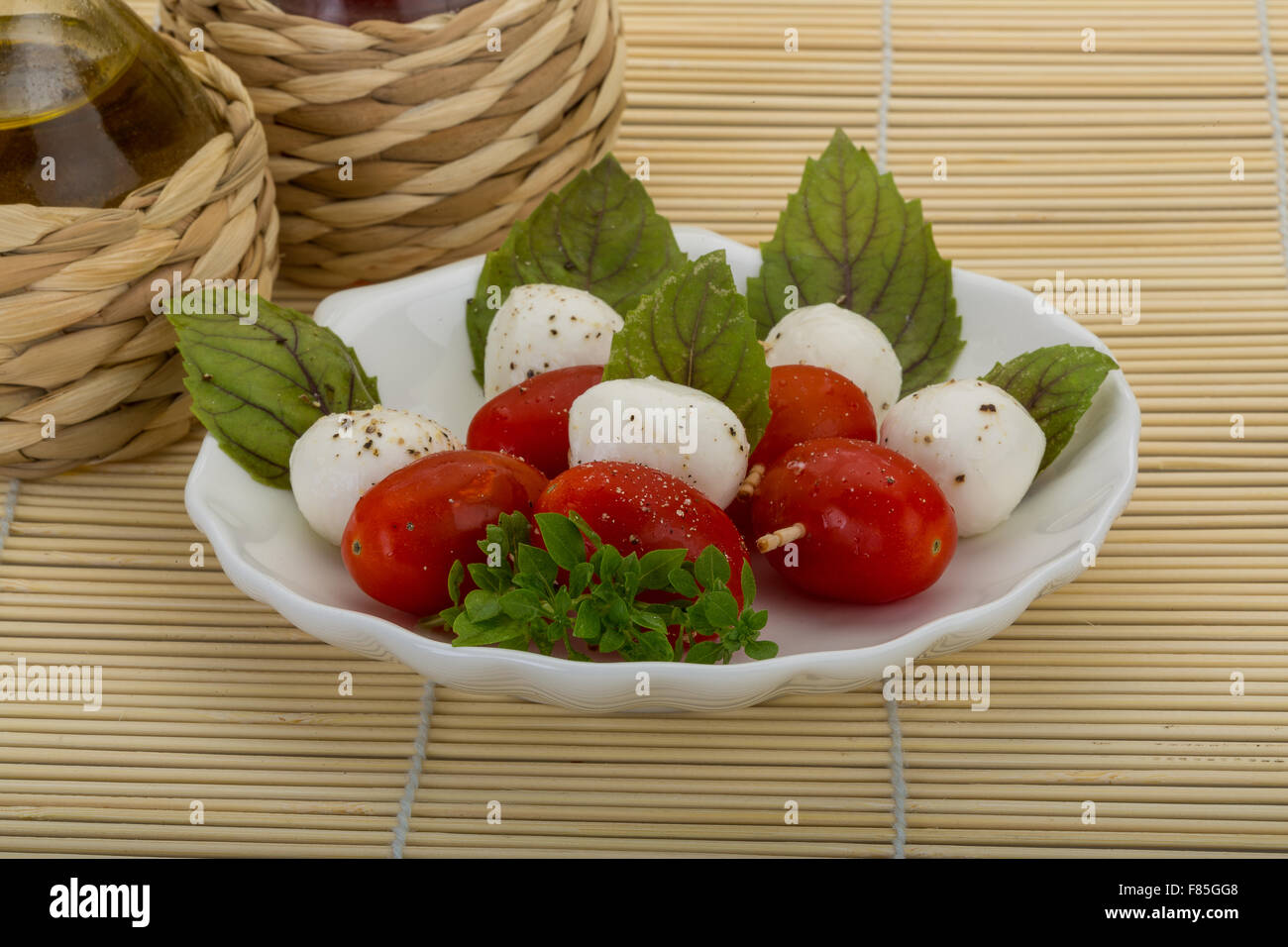 Famous italian caprese salad with fresh basil leaves Stock Photo - Alamy