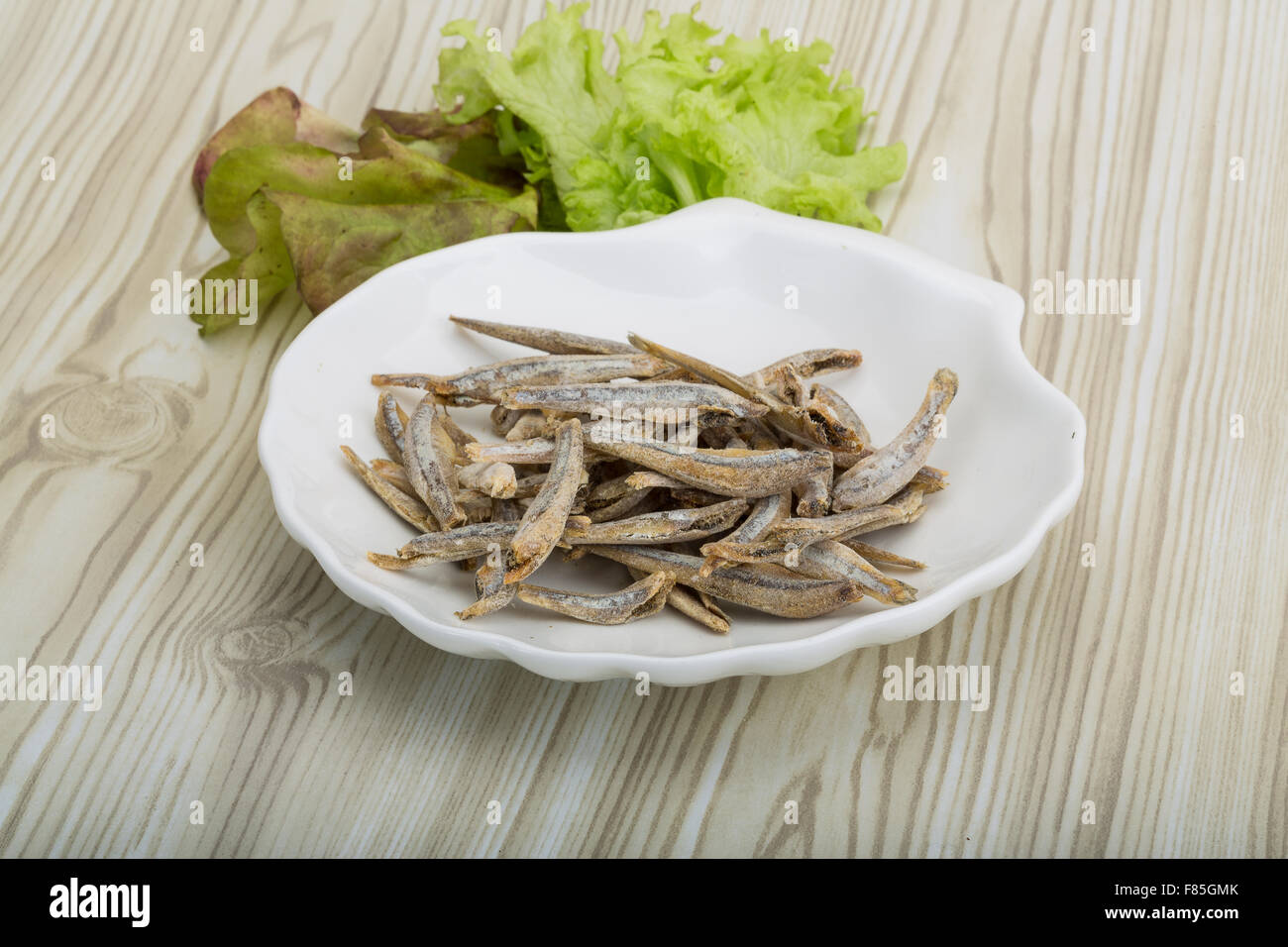 Dries anchovy - small fishes in the bowl Stock Photo - Alamy