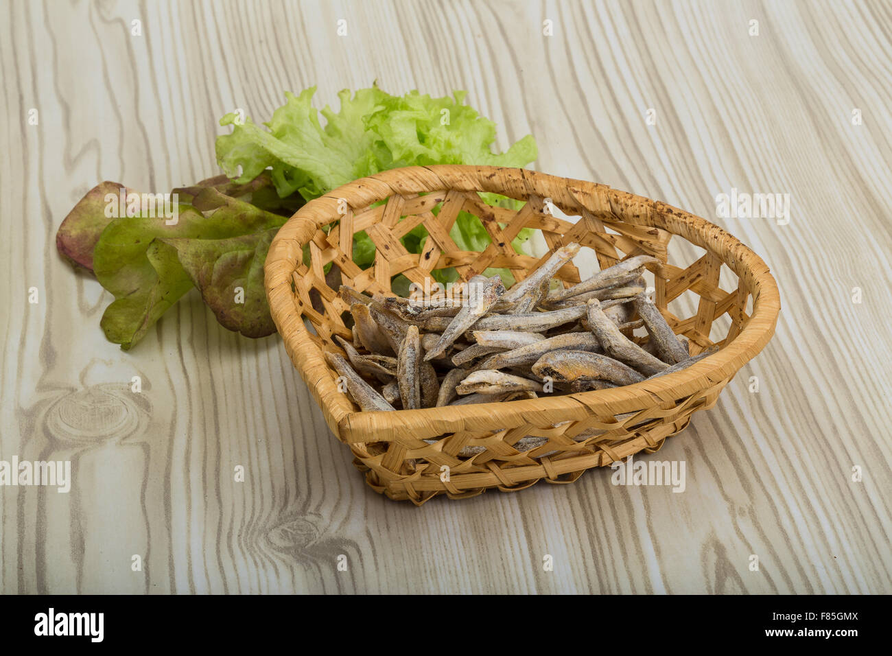 Dries anchovy - small fishes in the bowl Stock Photo - Alamy
