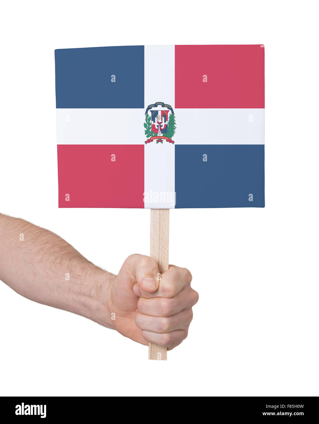 Hand holding small card, isolated on white - Flag of Dominican Republic ...
