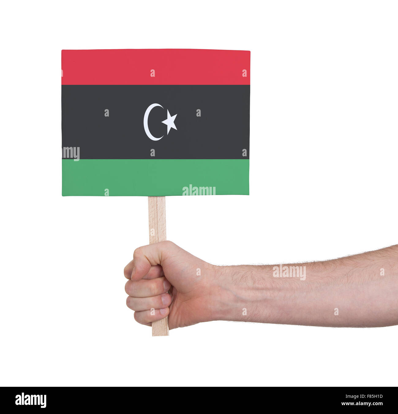 Hand holding small card, isolated on white - Flag of Libya Stock Photo ...