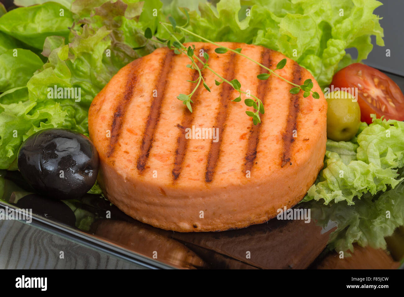 Grilled Fish cakes in the bowl with salad leaves Stock Photo - Alamy