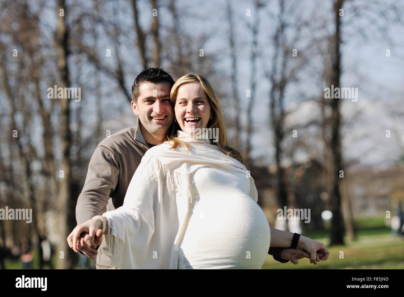 happy young married family couple outdoor in nature have fun and ...