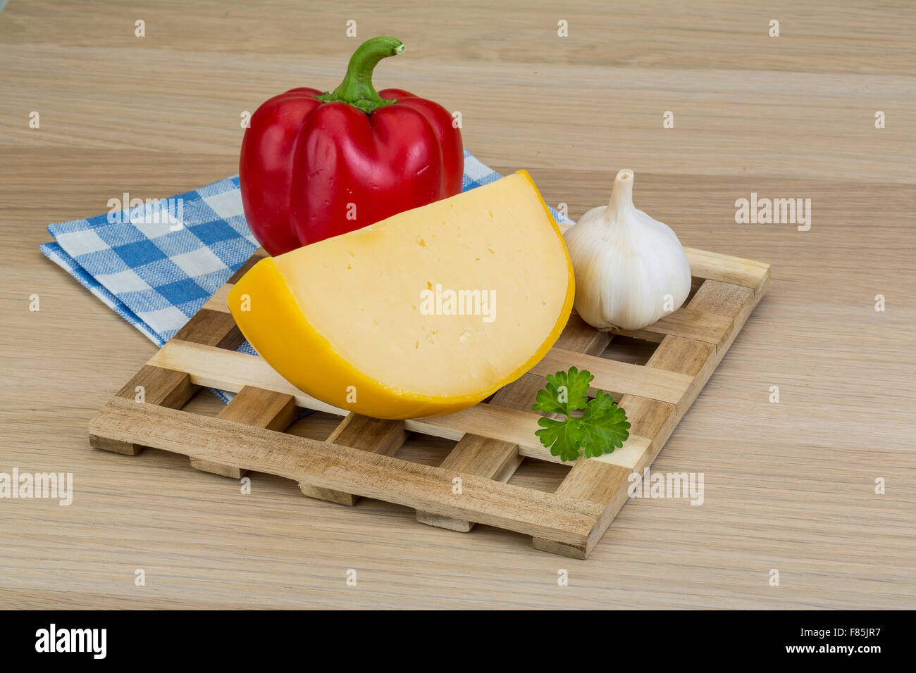 Yellow round cheese on the wood background Stock Photo - Alamy