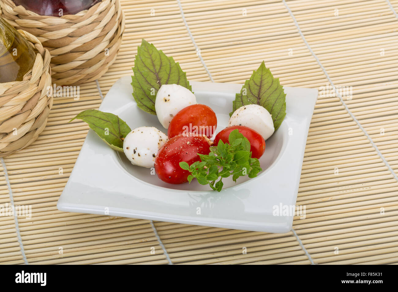 Famous italian caprese salad with fresh basil leaves Stock Photo - Alamy
