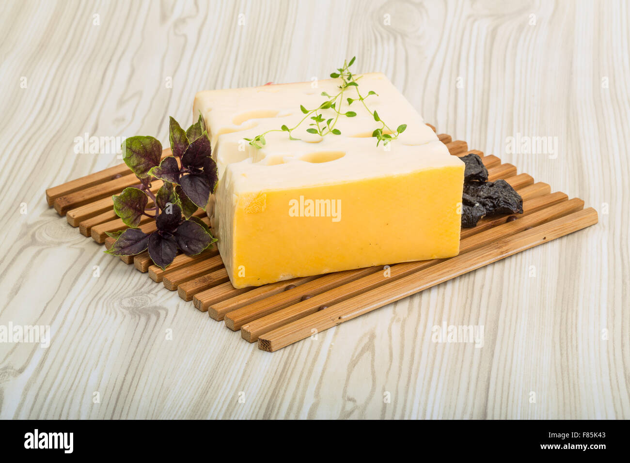 Yellow Cheese maasdam - with thyme and basil Stock Photo - Alamy