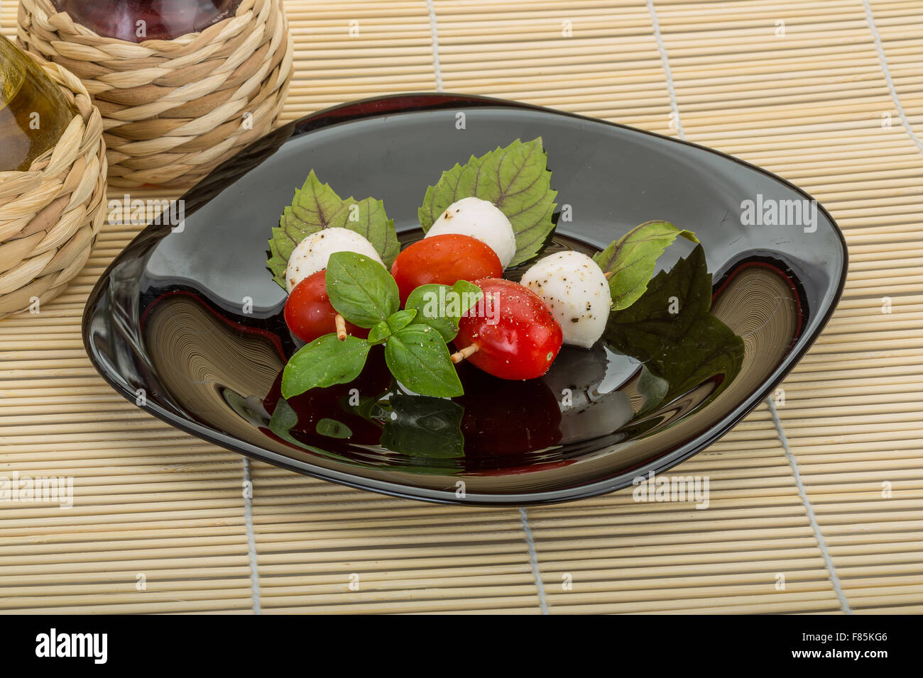 Famous italian caprese salad with fresh basil leaves Stock Photo - Alamy