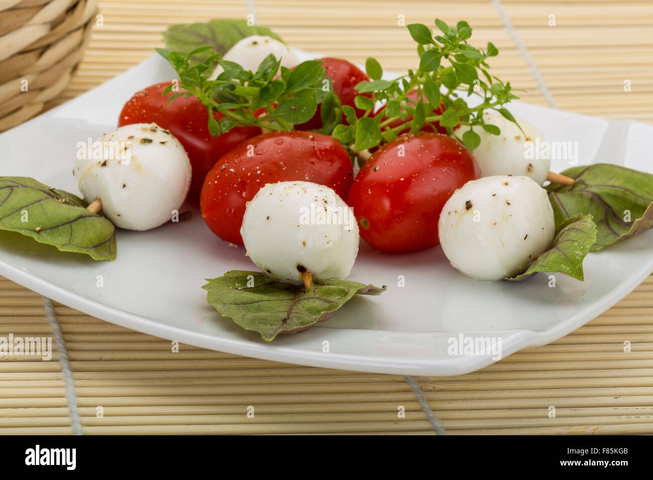 Famous italian caprese salad with fresh basil leaves Stock Photo - Alamy
