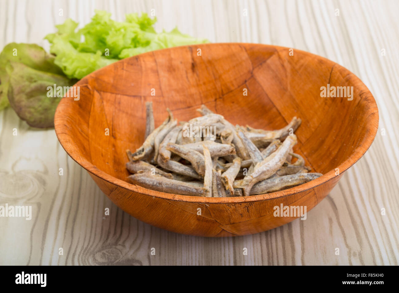Dries anchovy - small fishes in the bowl Stock Photo - Alamy