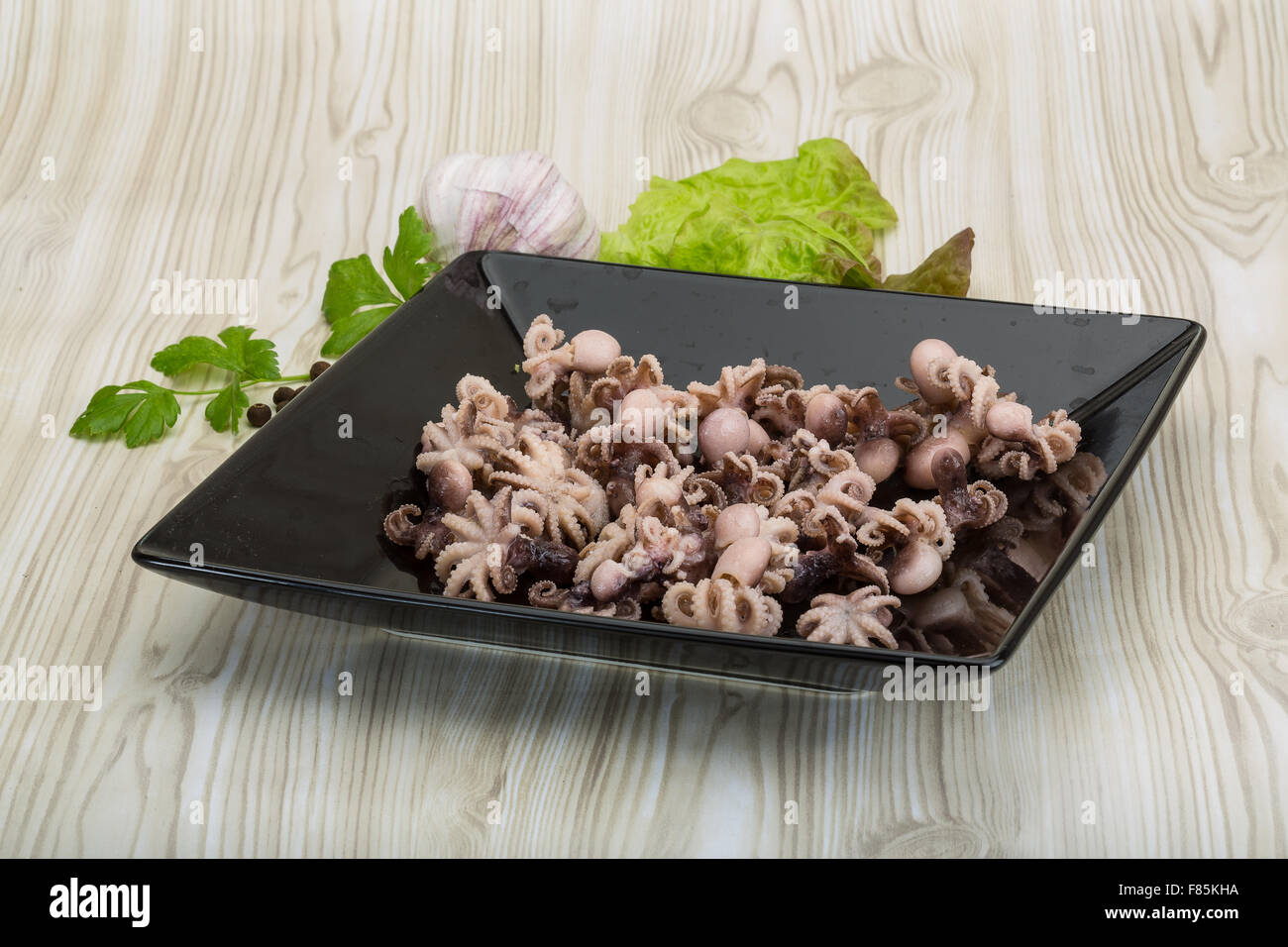 Boiled octopus - mini seafood in the bowl Stock Photo - Alamy