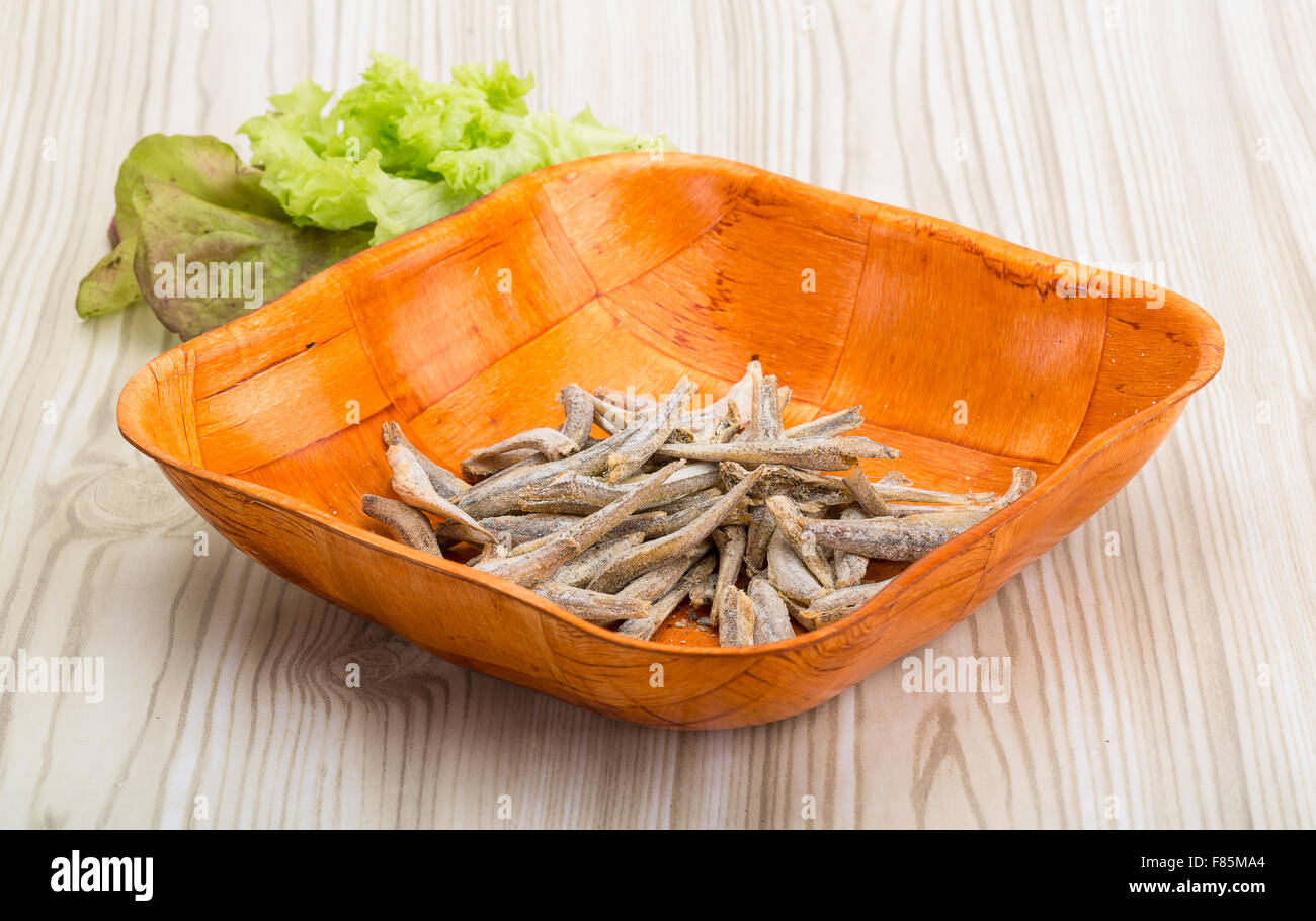 Dries anchovy - small fishes in the bowl Stock Photo - Alamy