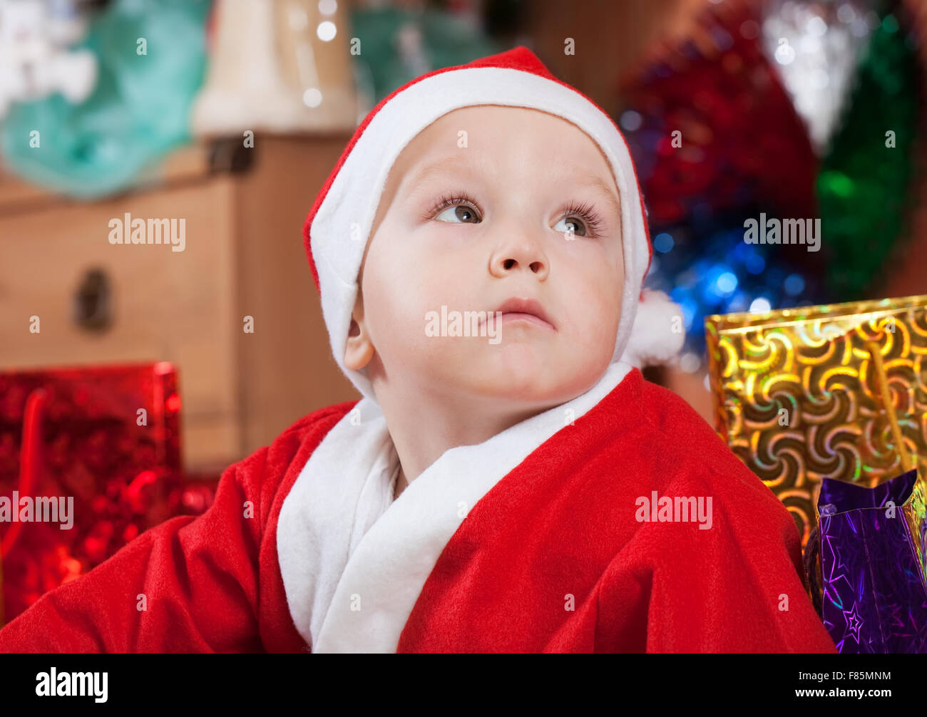 Boy dressed like Santa Claus at home Stock Photo - Alamy