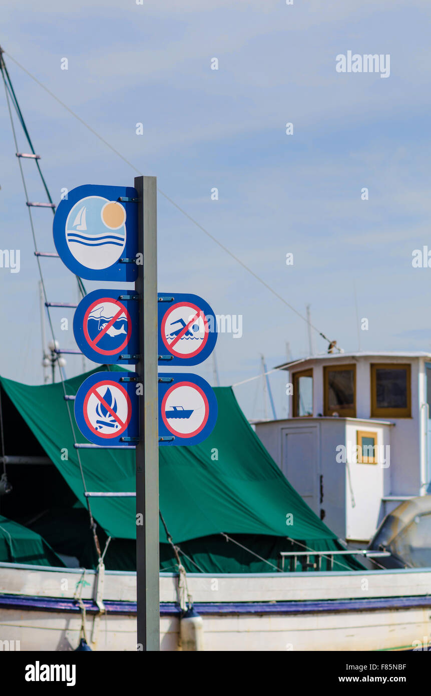 Signpost with safety instructions on a harbor pier Stock Photo - Alamy