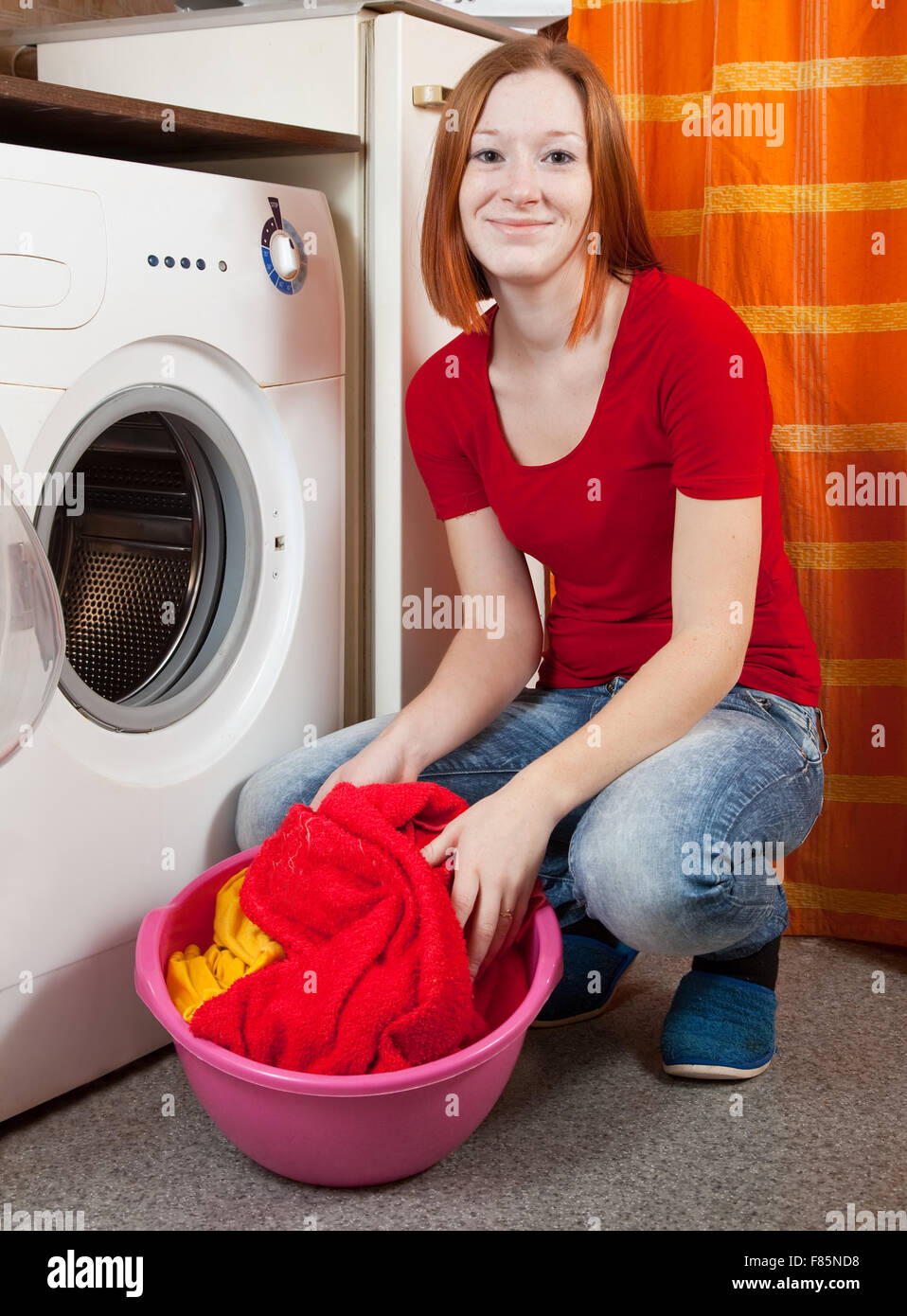 Young woman doing laundry at her home Stock Photo - Alamy