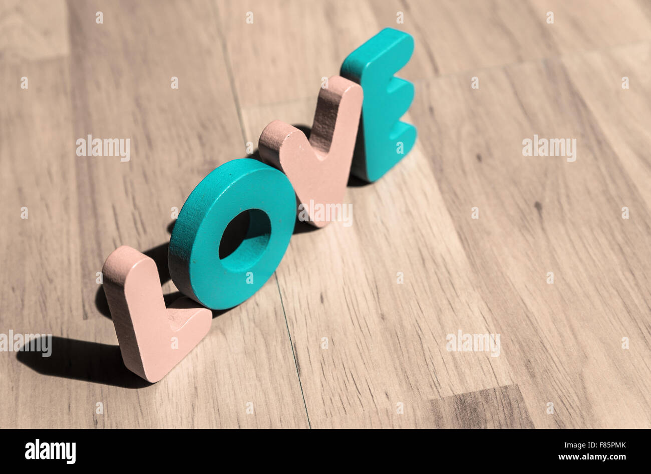 Wooden word LOVE on laminate floor in classic style Stock Photo - Alamy