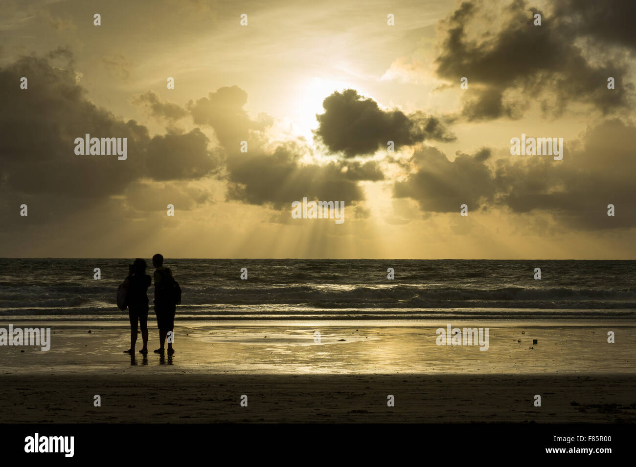 The rays of the sunset beat down onto the earth, with people trying to ...