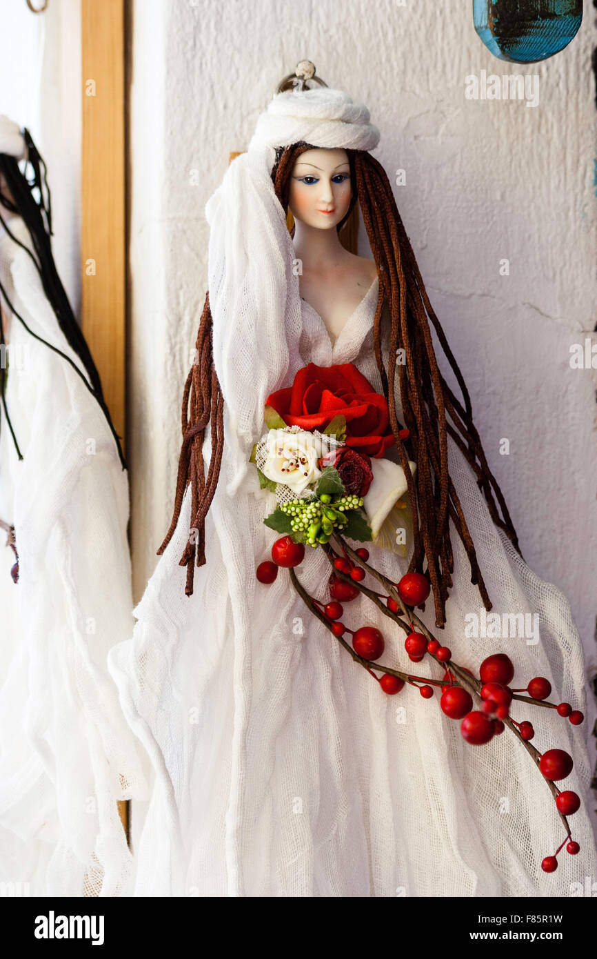Ornamental female figurine doll with rope stands for hair, wearing ...