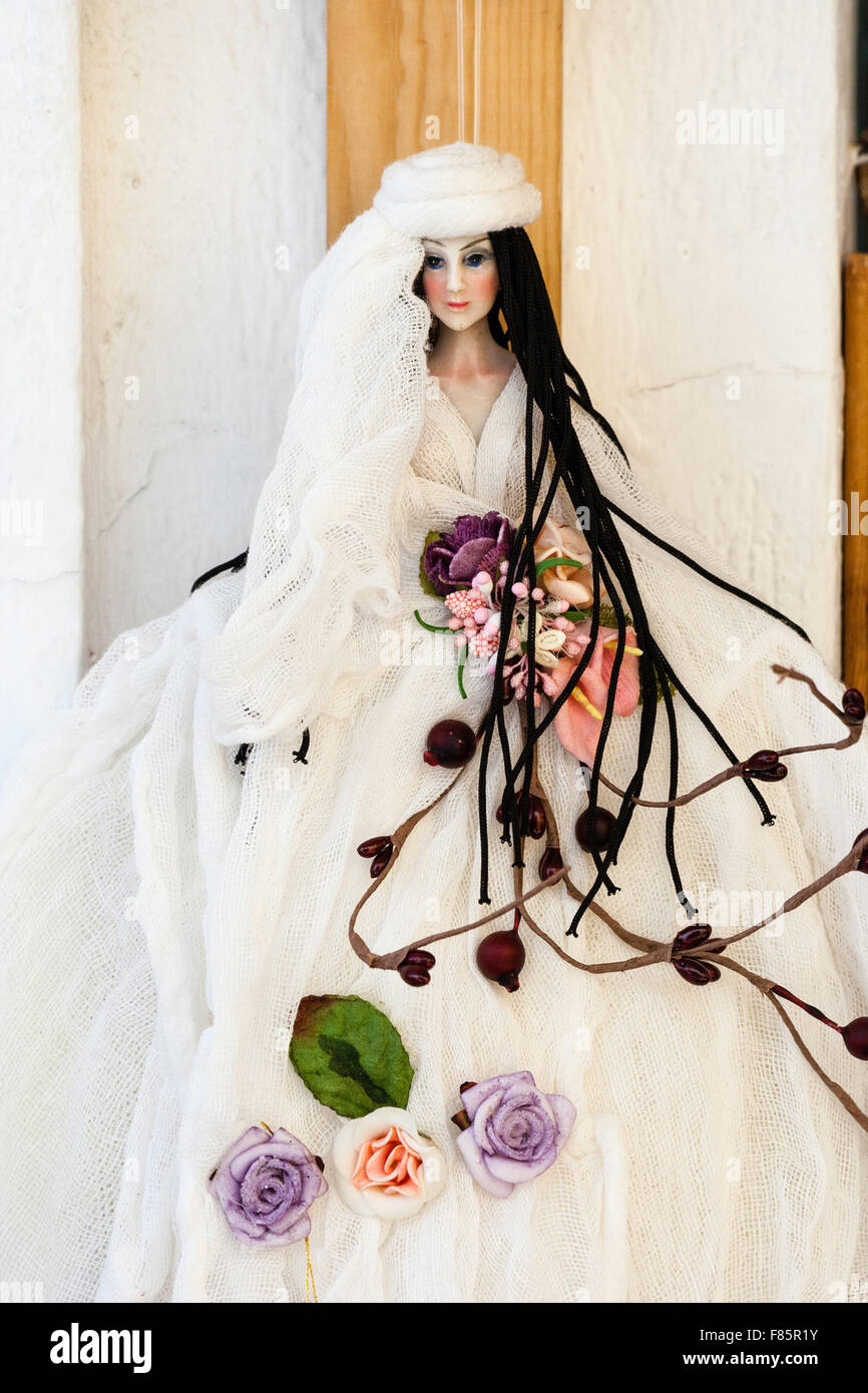 Ornamental female figurine doll with rope stands for hair, wearing ...