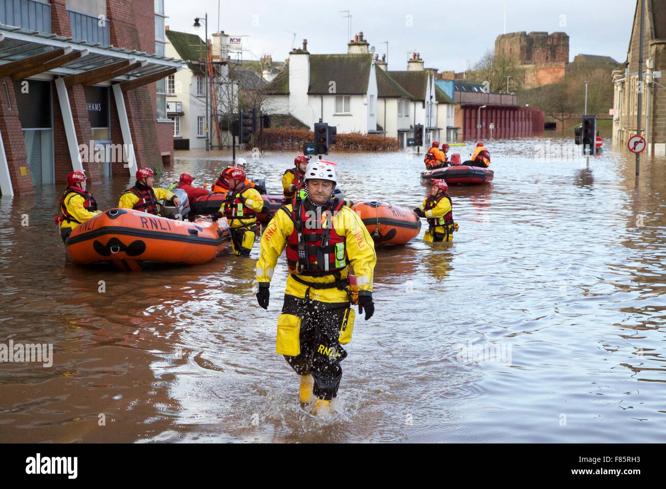 Cumbria Floods. 6th December 2015. RNLI rescue team volunteer wading ...