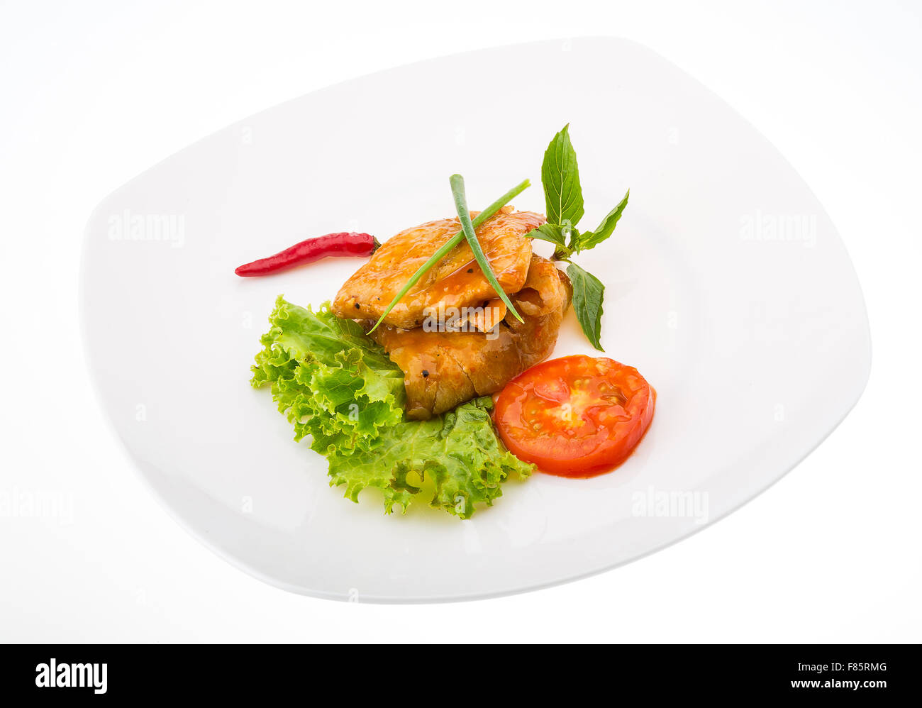 Baracuda steak with sauce and salad Stock Photo - Alamy
