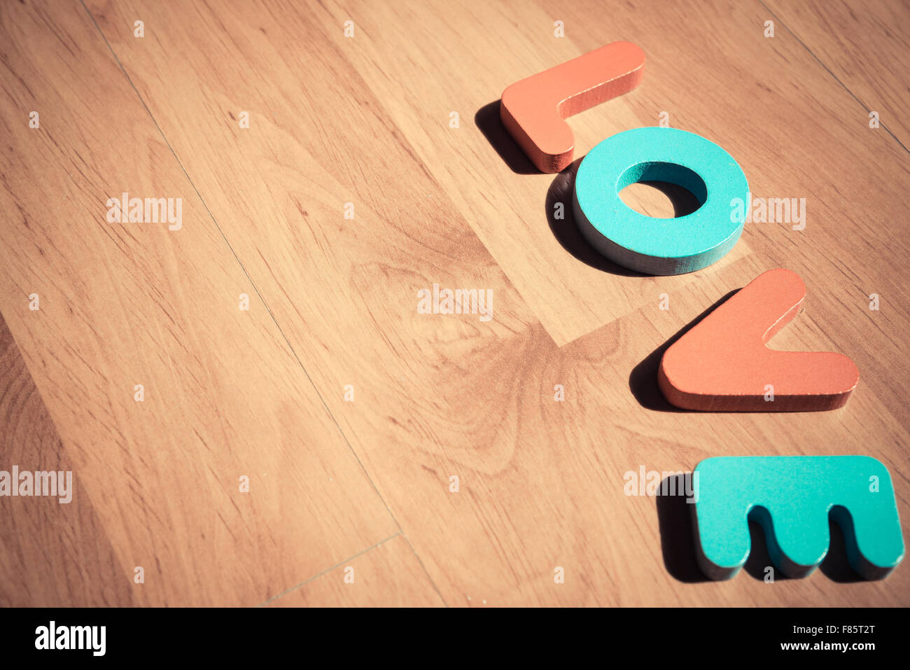 Wooden word LOVE on laminate floor Stock Photo - Alamy