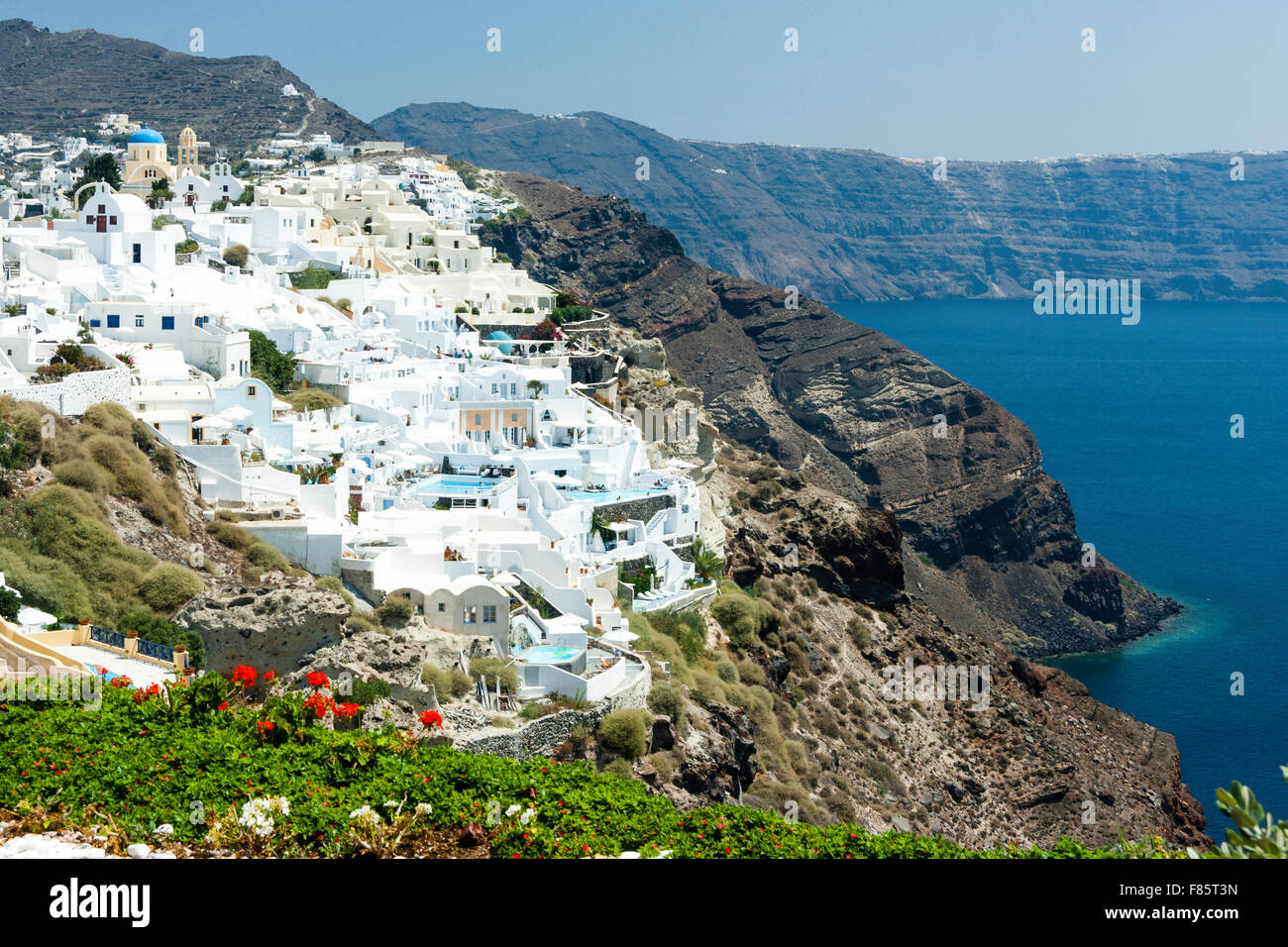 Santorini. Clifftop view along rim of caldera with part of Oia town ...