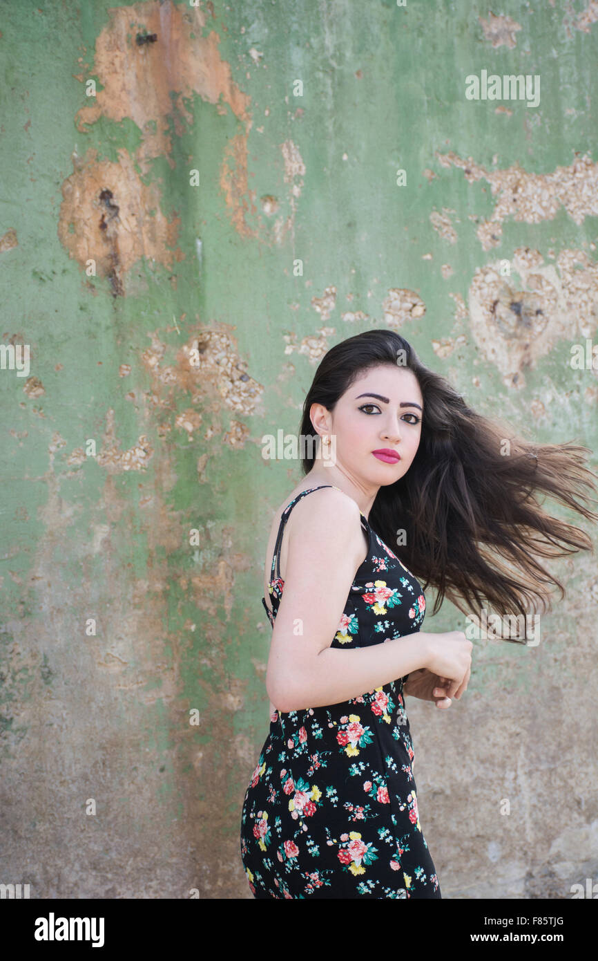 Young woman flicking hair outdoors Stock Photo - Alamy