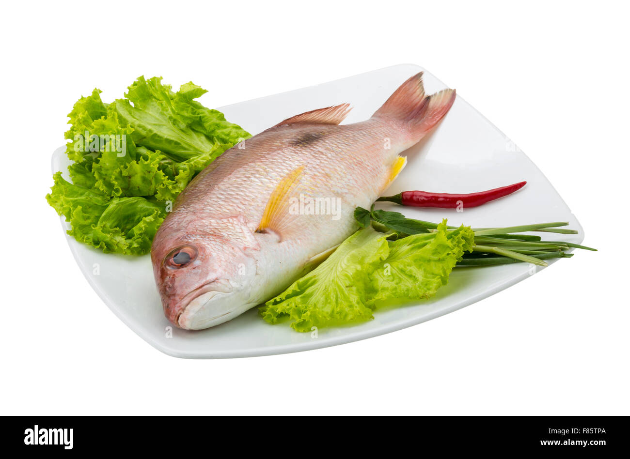 Raw red snapper with salad leaves Stock Photo - Alamy