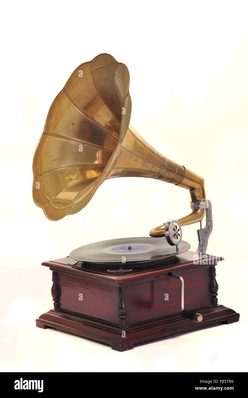 retro old gramophone with horn speaker for playing music over plates ...
