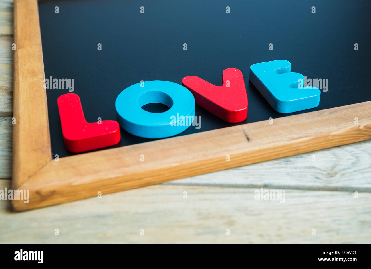 Wooden word LOVE on the corner of Black board 1 Stock Photo - Alamy