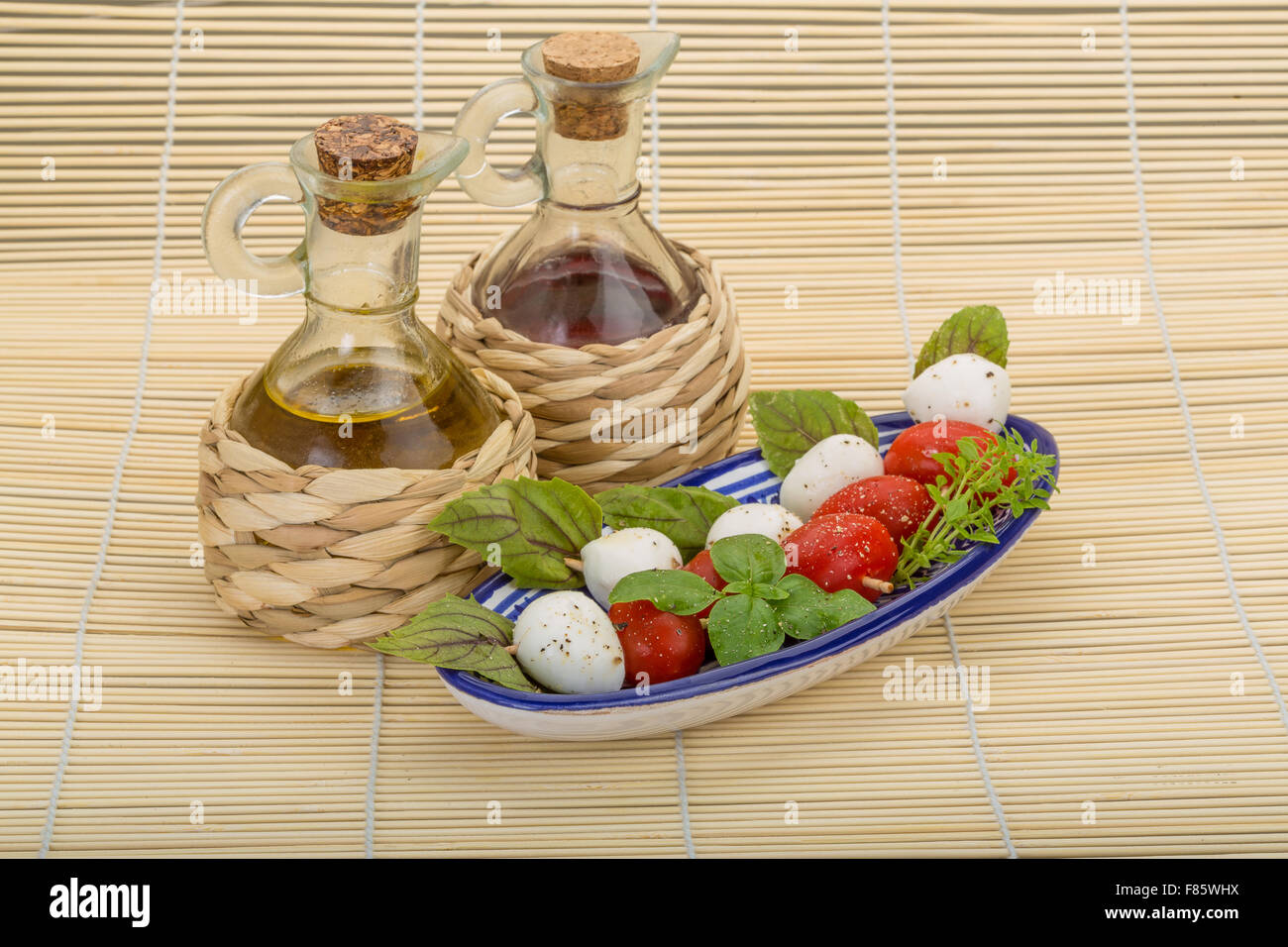 Famous italian caprese salad with fresh basil leaves Stock Photo - Alamy