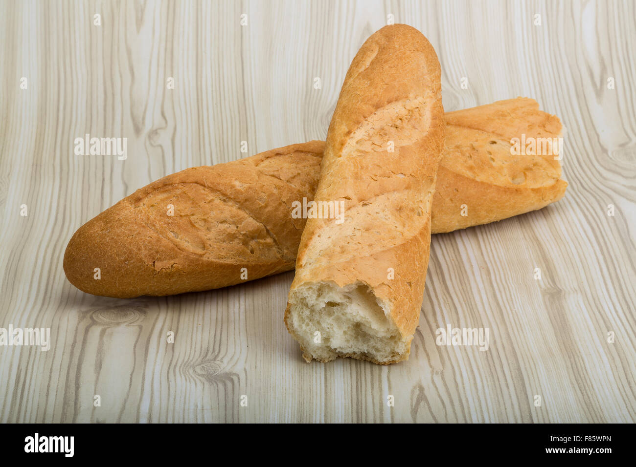 Broken fresh loaf bread on the board Stock Photo - Alamy