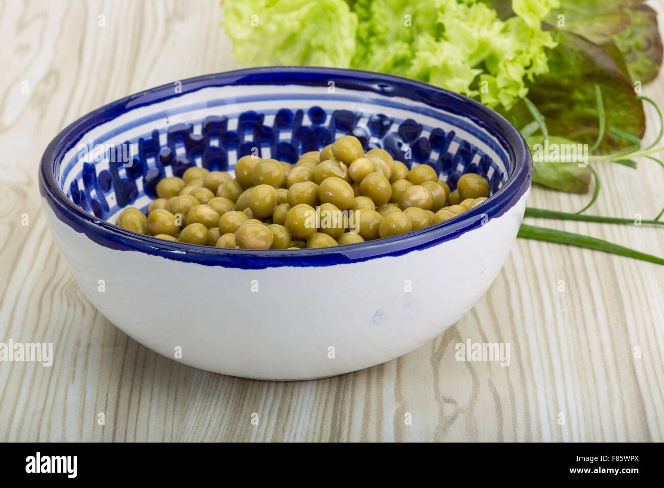 Marinated peas - in the bowl with salad leaves Stock Photo - Alamy
