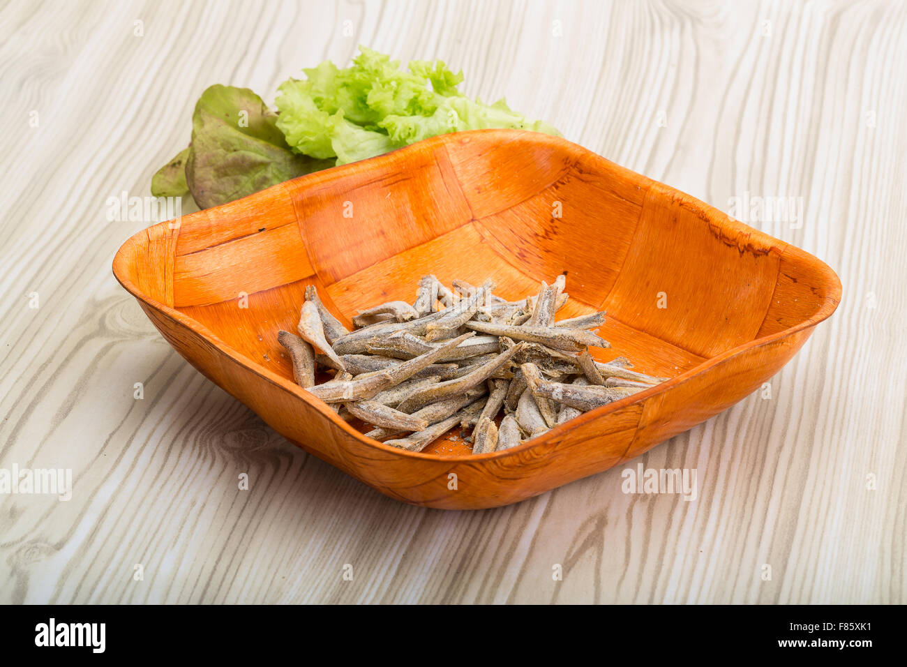 Dries anchovy - small fishes in the bowl Stock Photo - Alamy