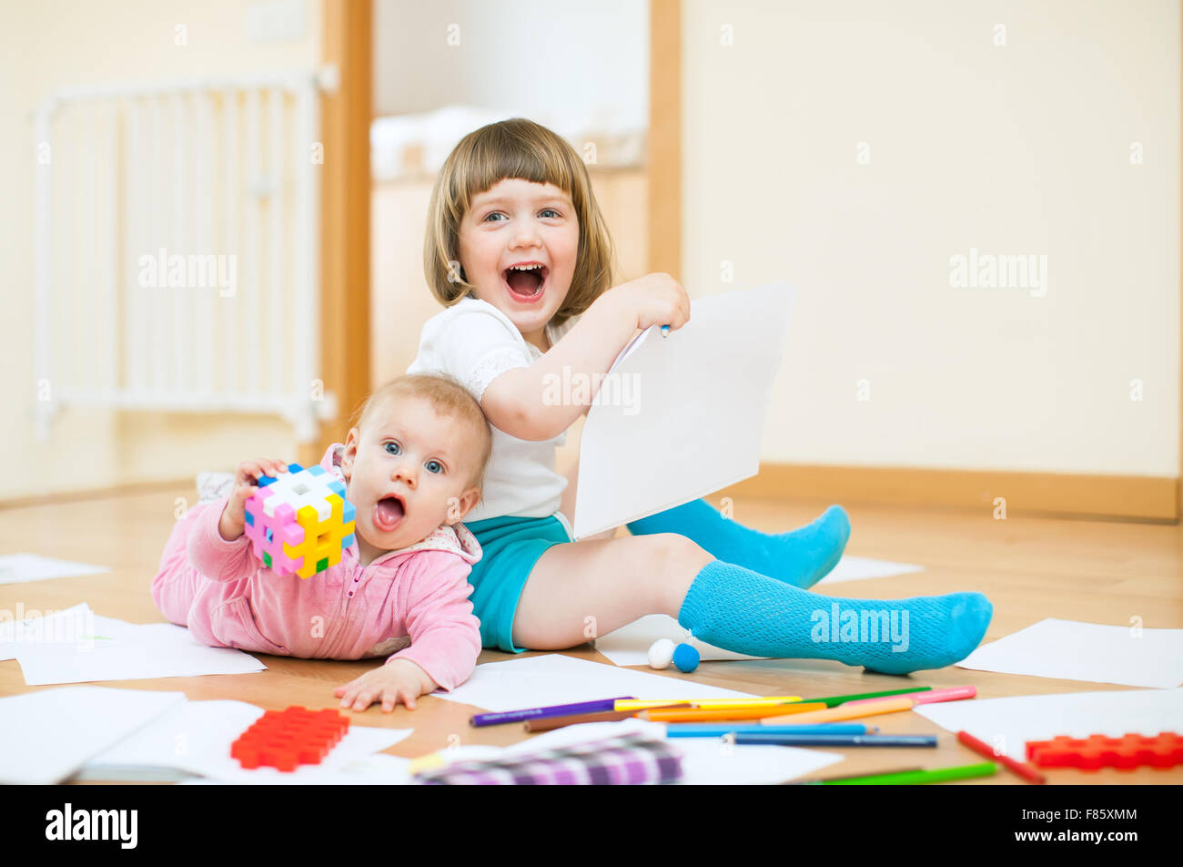 Two happy children together in home interior Stock Photo - Alamy