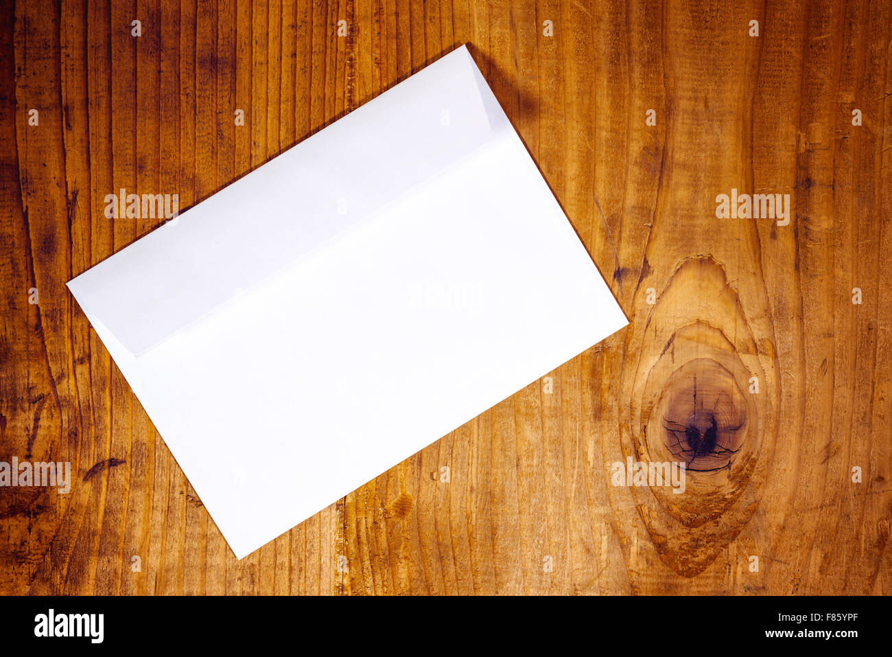 Blank white envelope on wooden office desk, retro toned, top view Stock ...