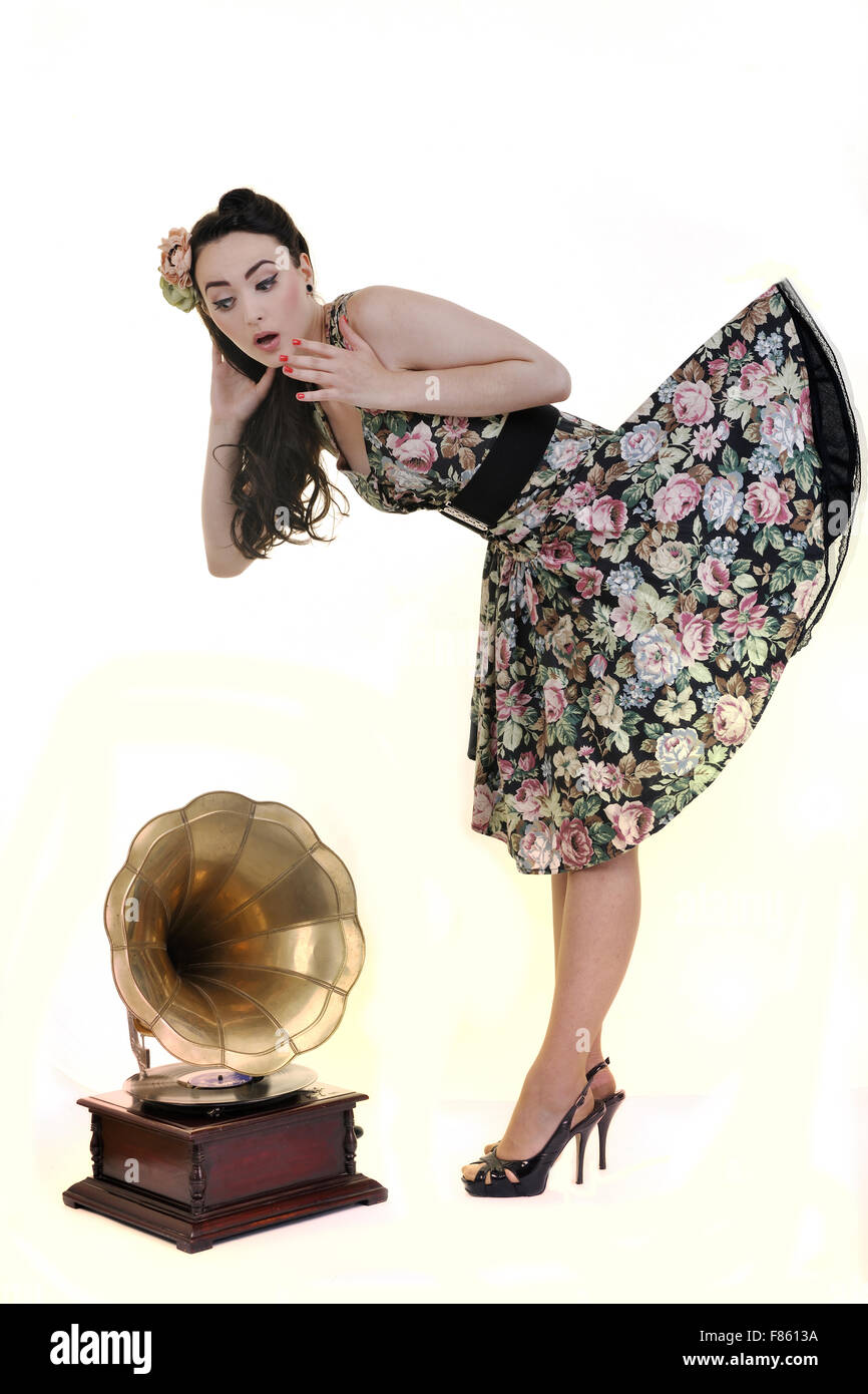 pretty girl listening music on old gramophone isolated on white in ...