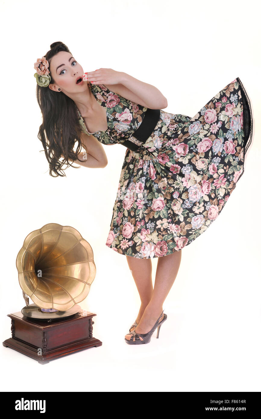 pretty girl listening music on old gramophone isolated on white in ...