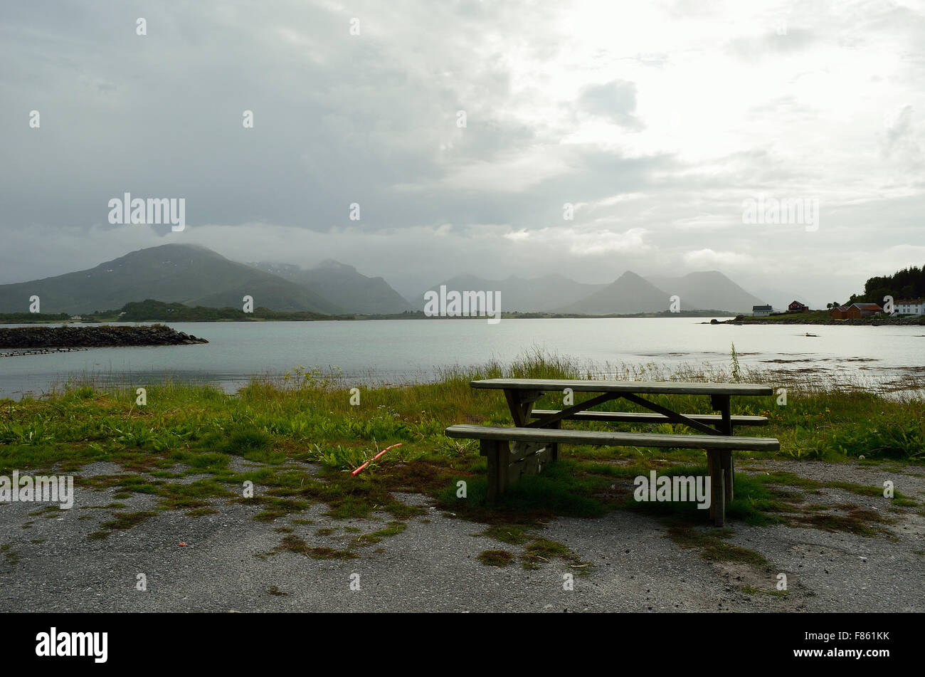 bench near sea shore with mountain background Stock Photo - Alamy