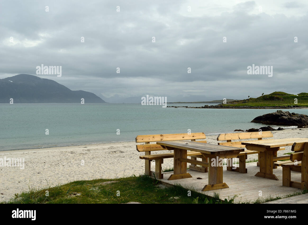 bench near sea shore with mountain background Stock Photo - Alamy