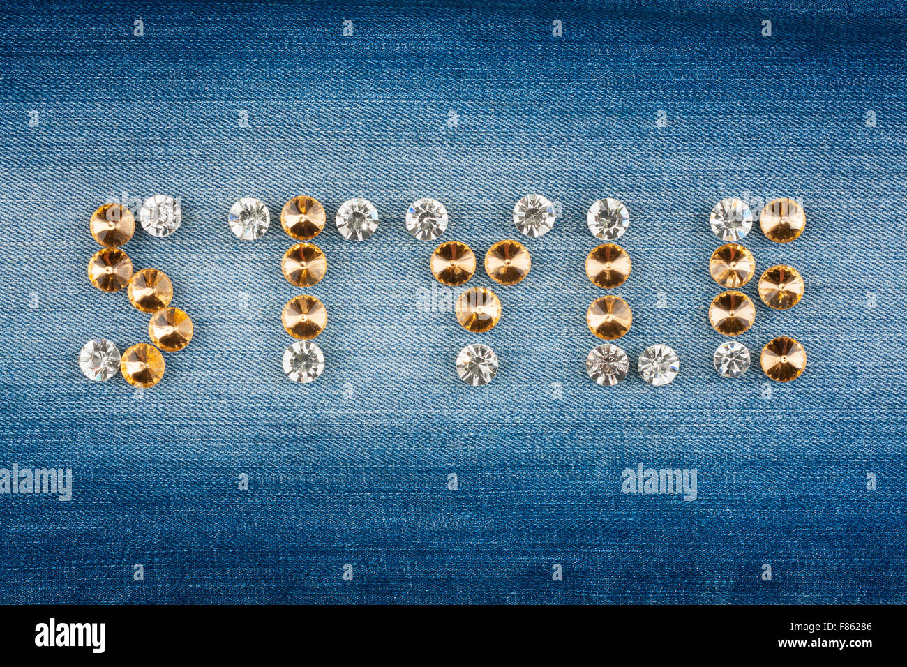 Word style made of rhinestones on denim fabric, as background, texture ...