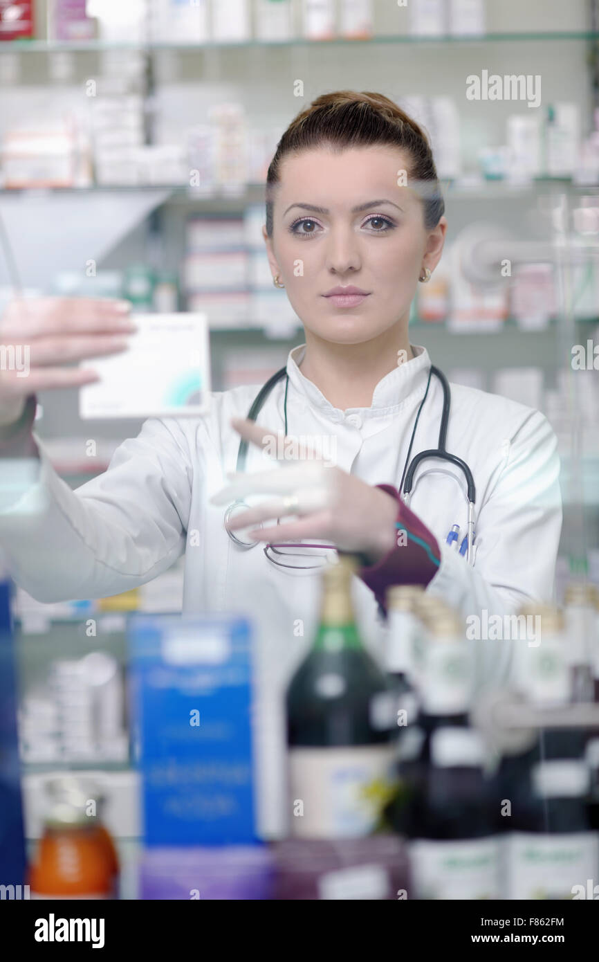 Happy cheerful pharmacist chemist woman standing in pharmacy drugstore ...