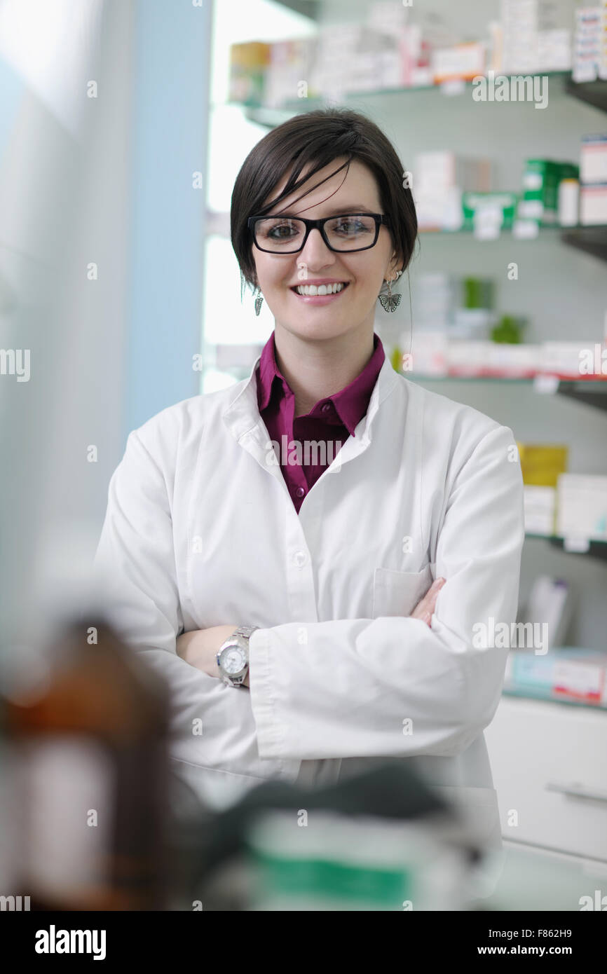 Happy cheerful pharmacist chemist woman standing in pharmacy drugstore ...