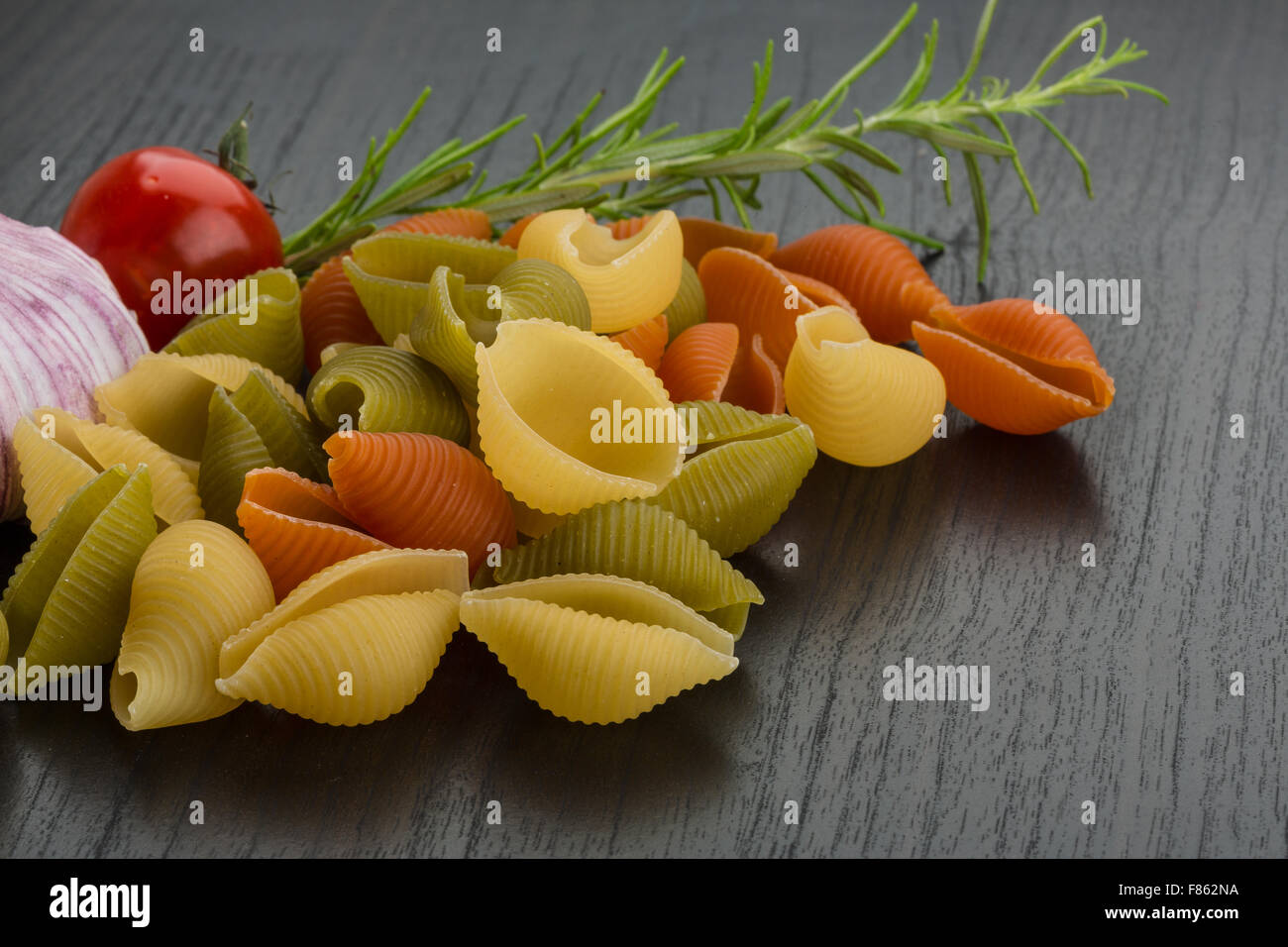 Raw shell pasta with herbs Stock Photo - Alamy