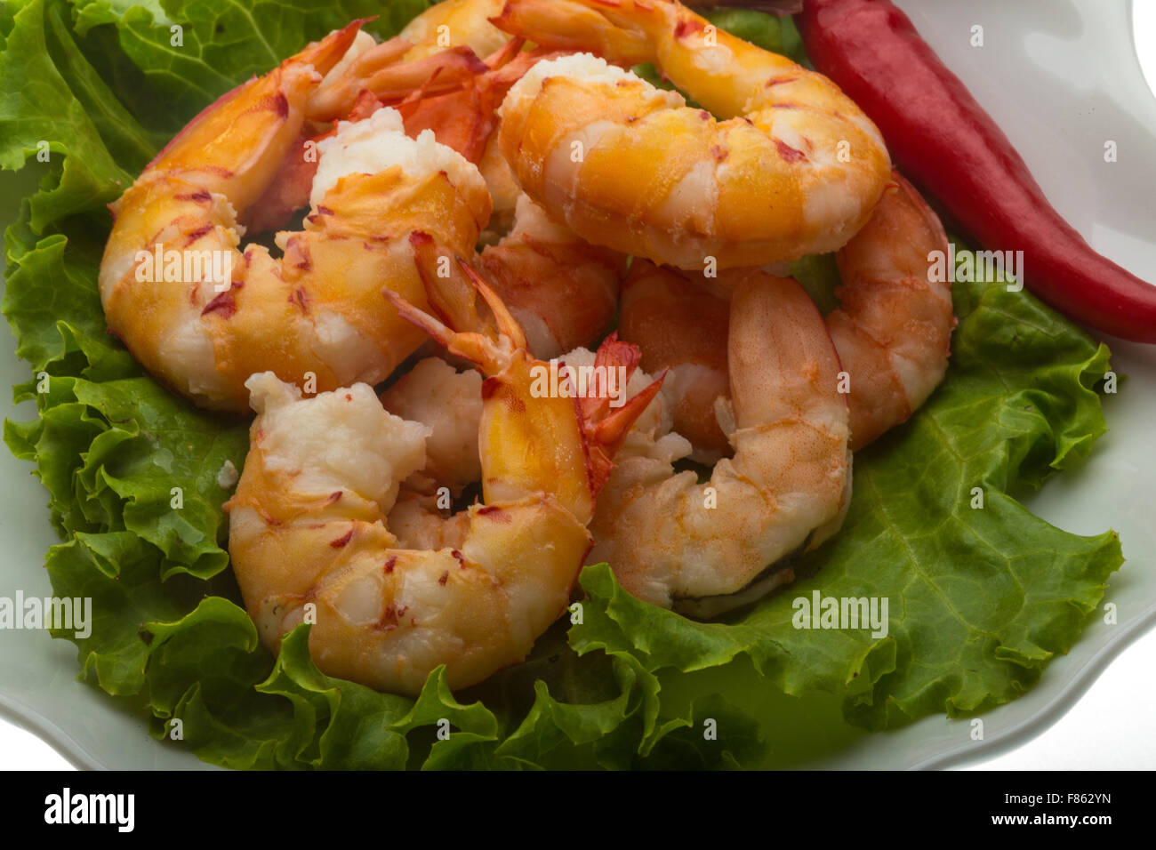 Unshelled king prawn heap with salad leaves Stock Photo - Alamy