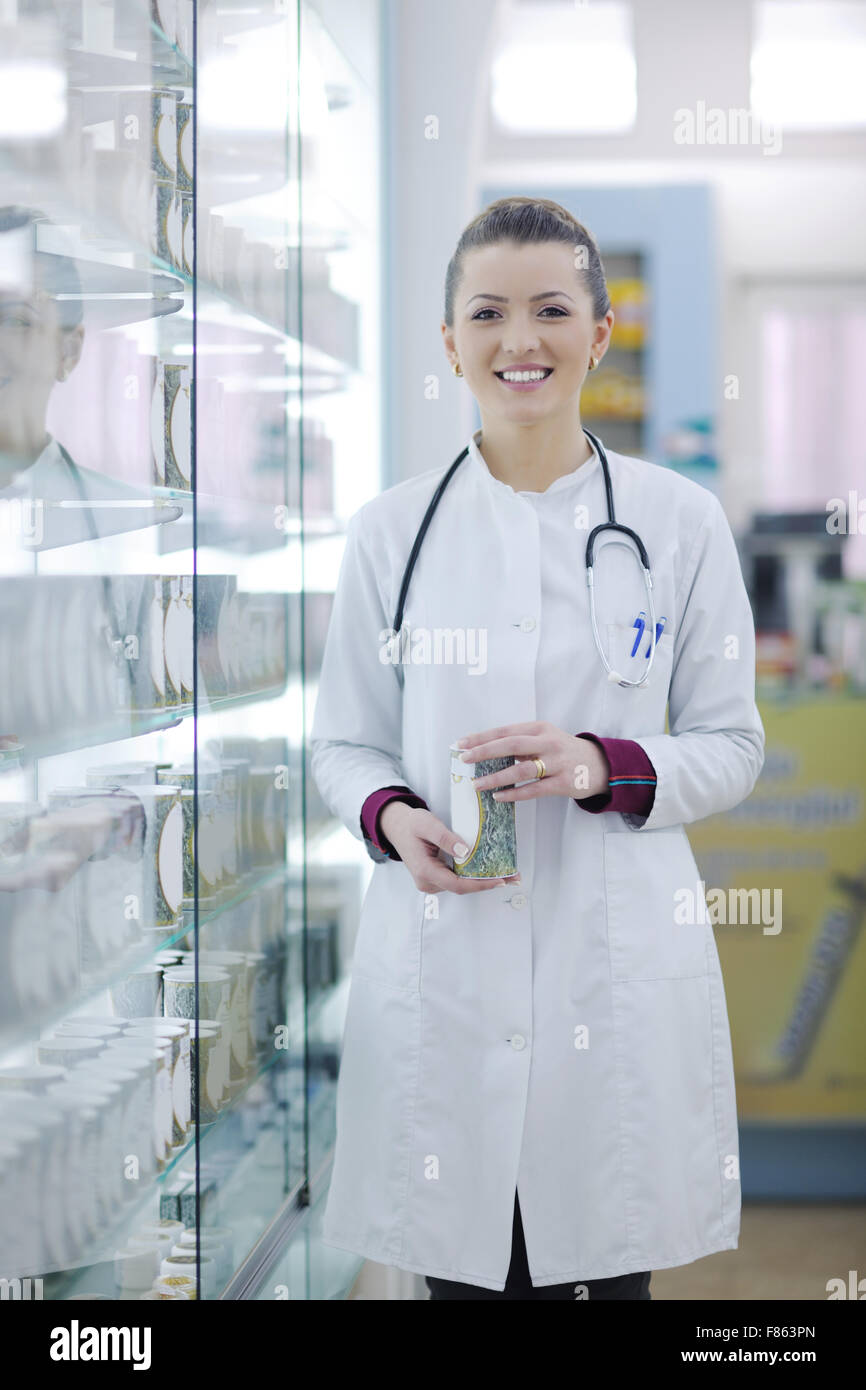 Happy cheerful pharmacist chemist woman standing in pharmacy drugstore ...