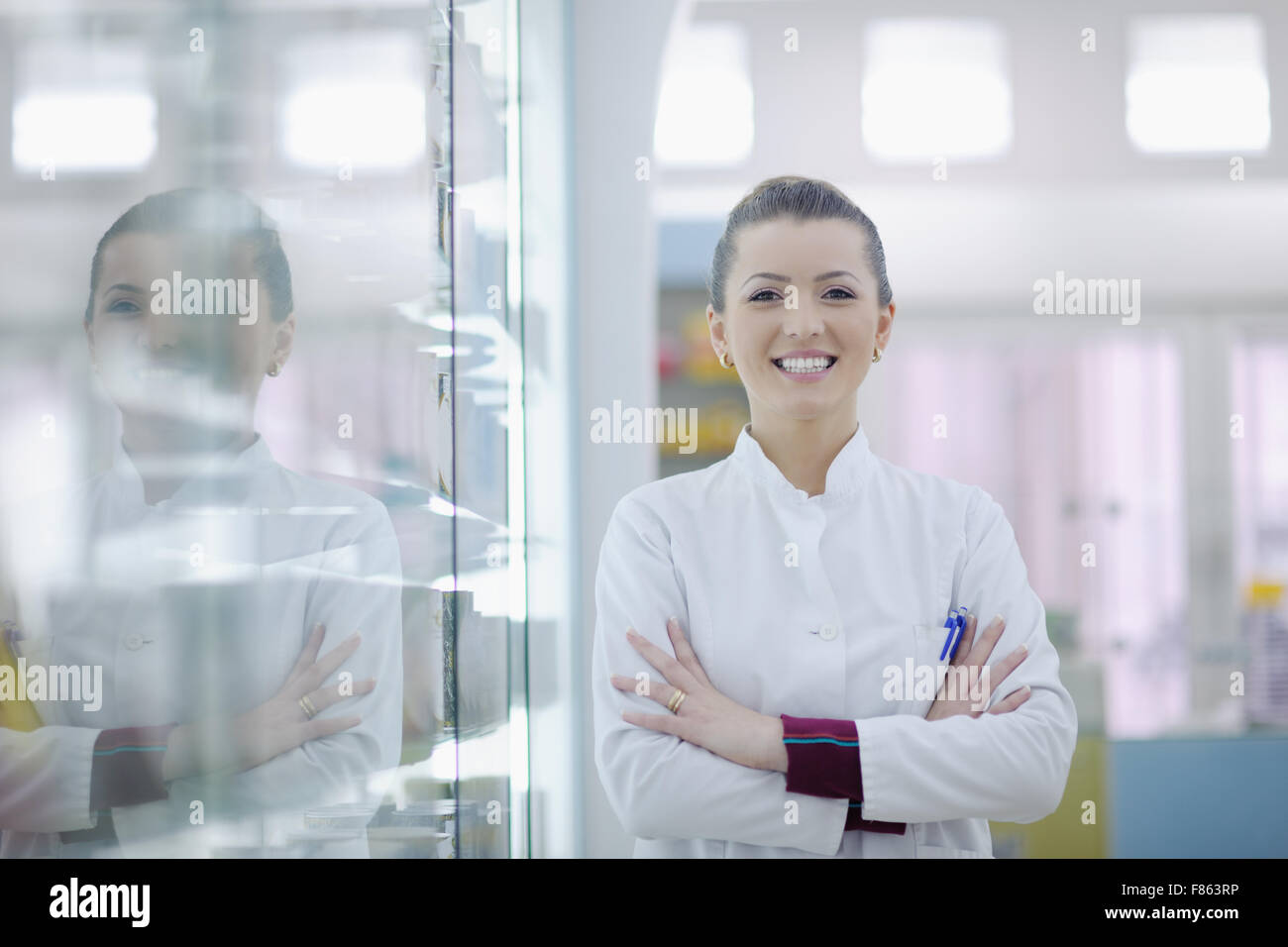 Happy cheerful pharmacist chemist woman standing in pharmacy drugstore ...