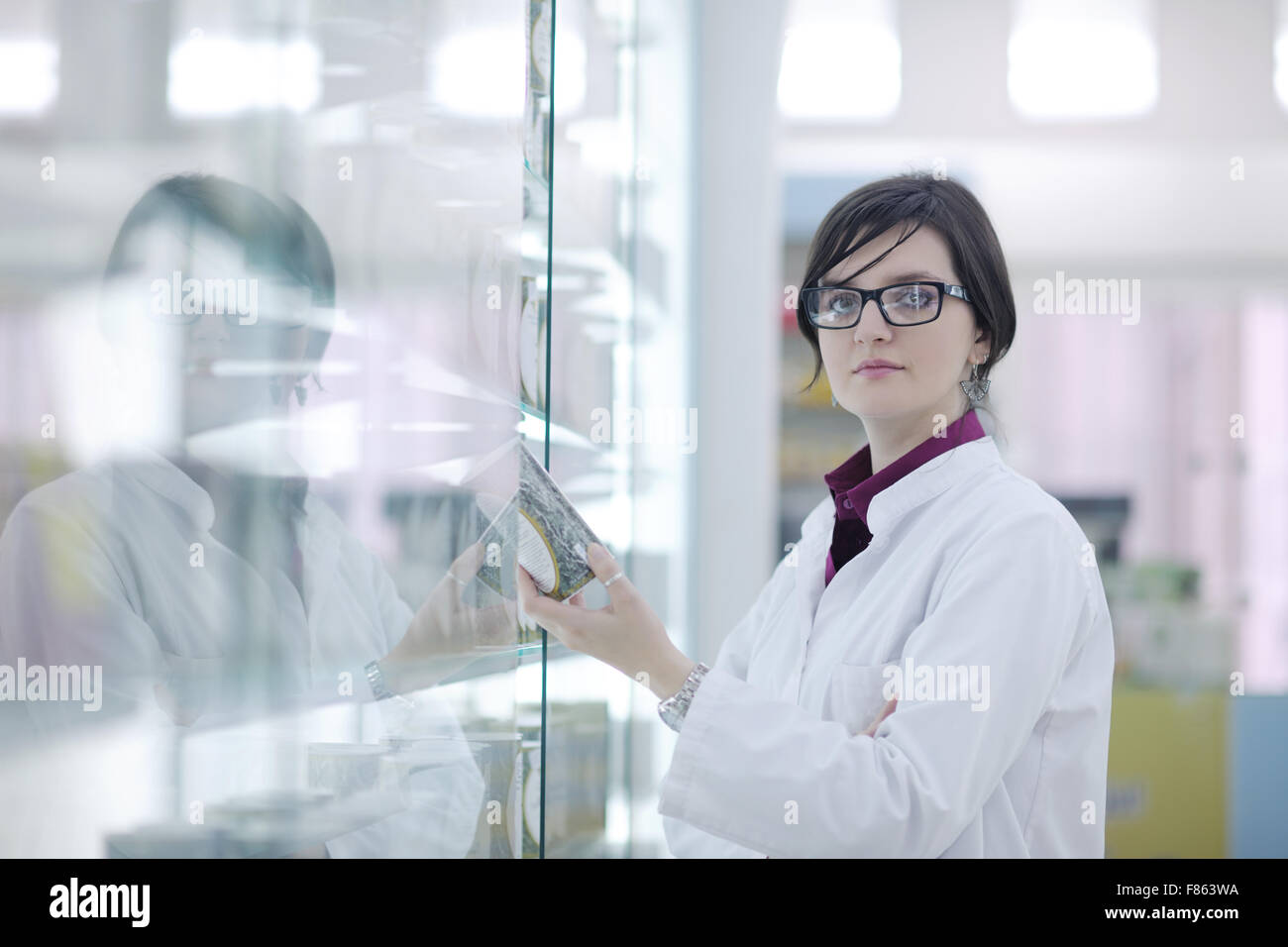 Happy cheerful pharmacist chemist woman standing in pharmacy drugstore ...