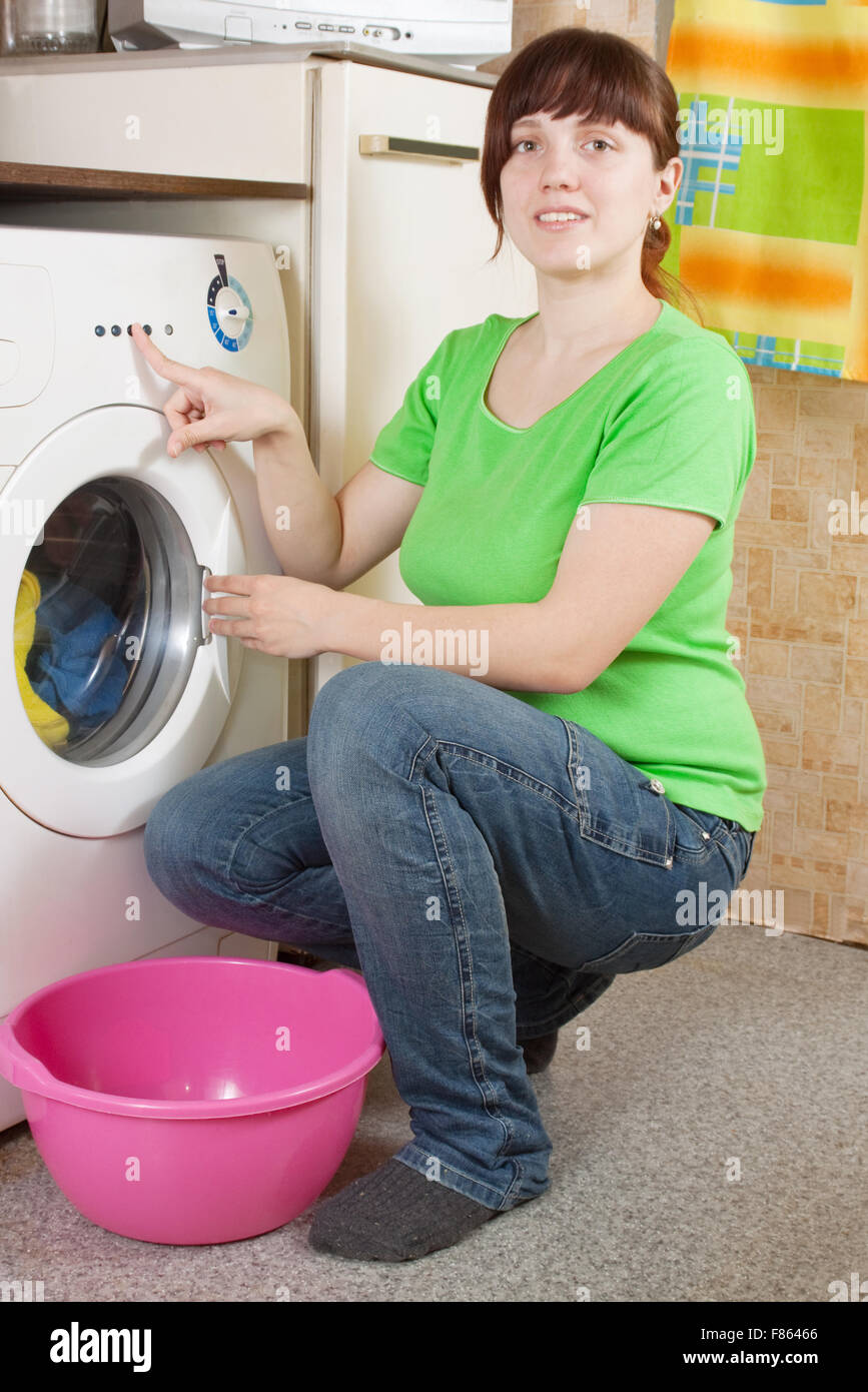 Young woman doing laundry at her home Stock Photo - Alamy